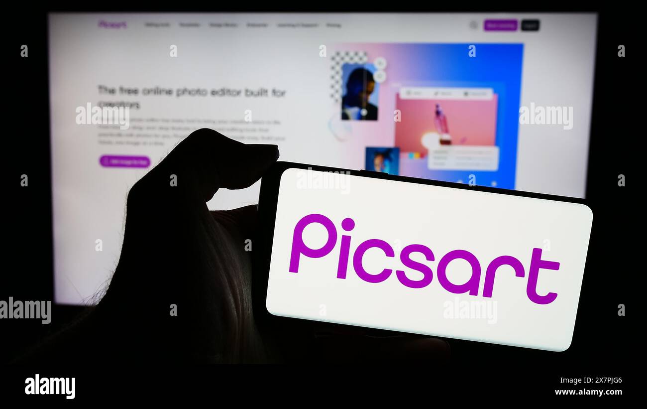 Person holding mobile phone with logo of American AI creation platform ...