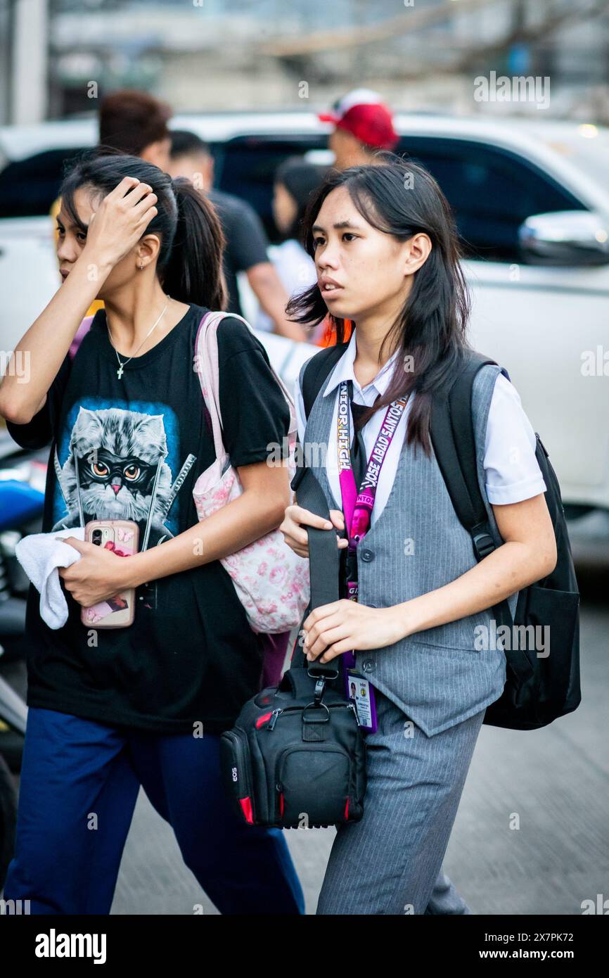Two young filipino girlfriends make their way home after work in the Tondo District Manila, The ...