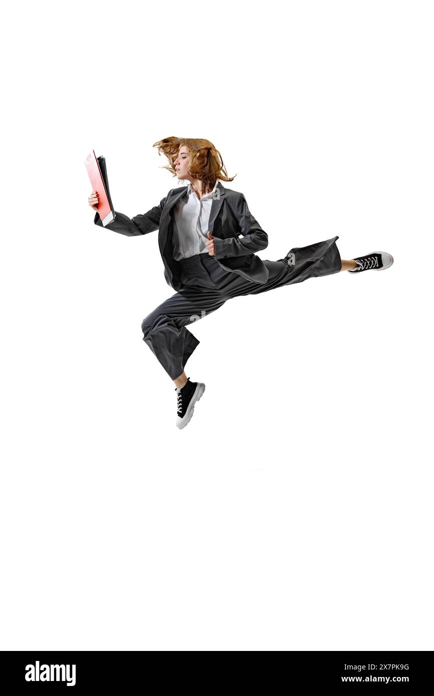 Leap of Success. Young woman in smart casual attire holding folder and ...