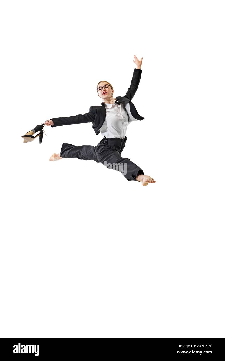 Professional woman in business suit executing perfect leap, holding her ...