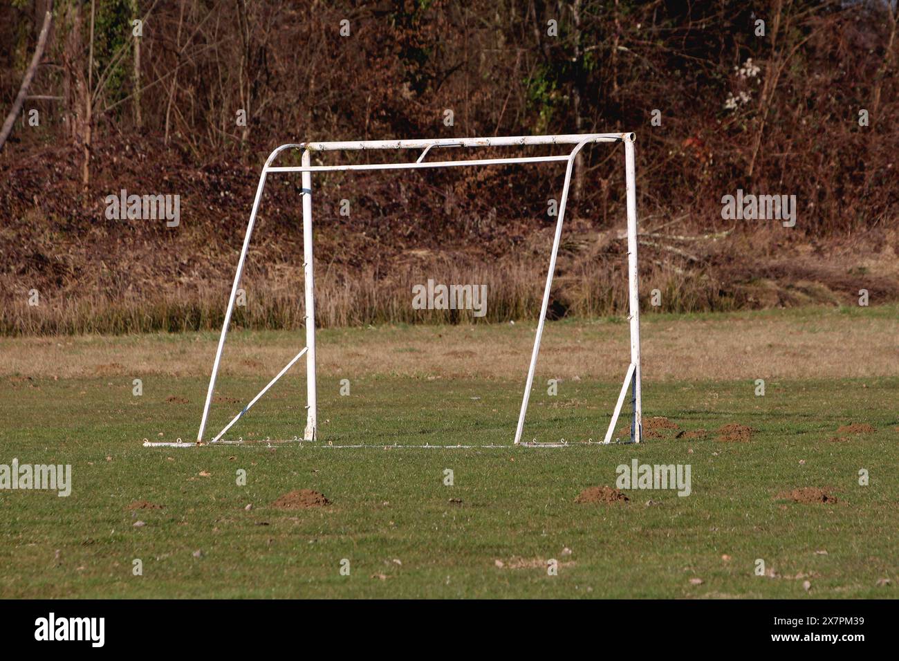 Back view of partially rusted white metal goal post without back net ...