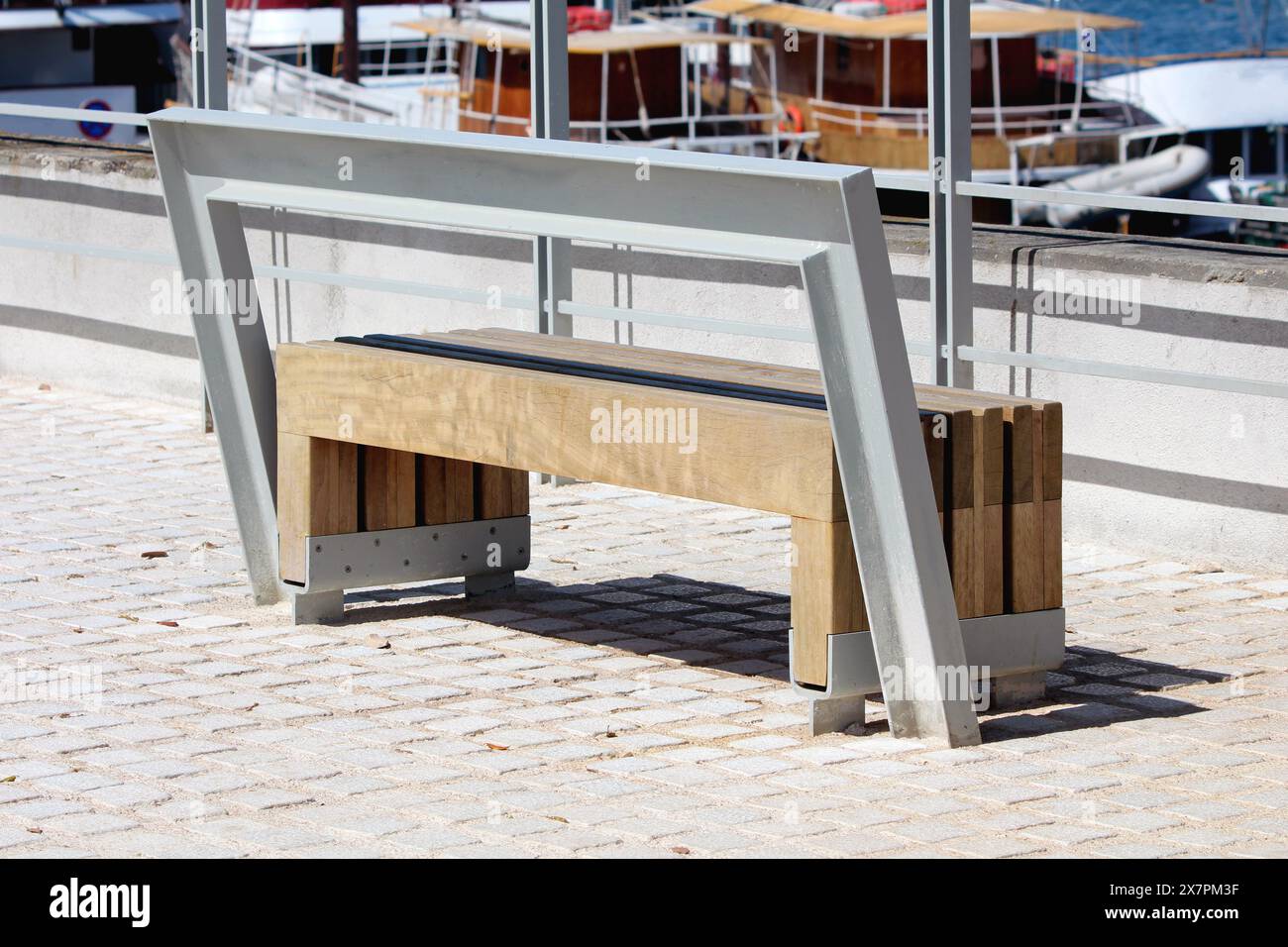 Back view of unusually looking artistic public bench made of strong ...