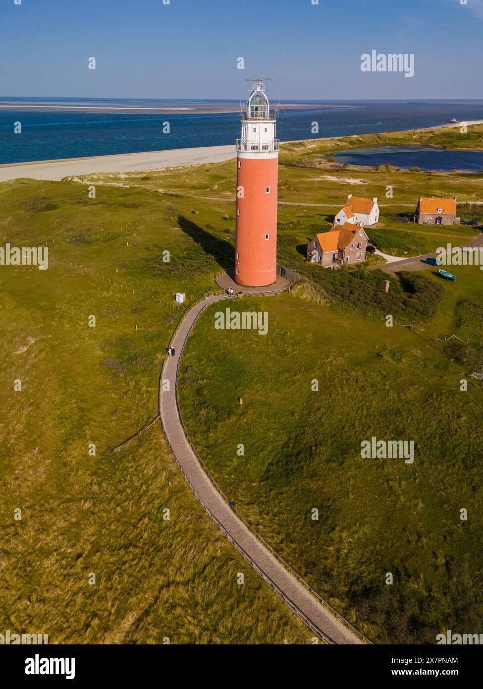 A stunning aerial view of a lighthouse standing tall near the ocean ...