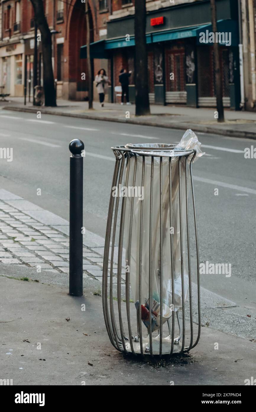 A typical Parisian trash can on a street in the 13th arrondissement ...