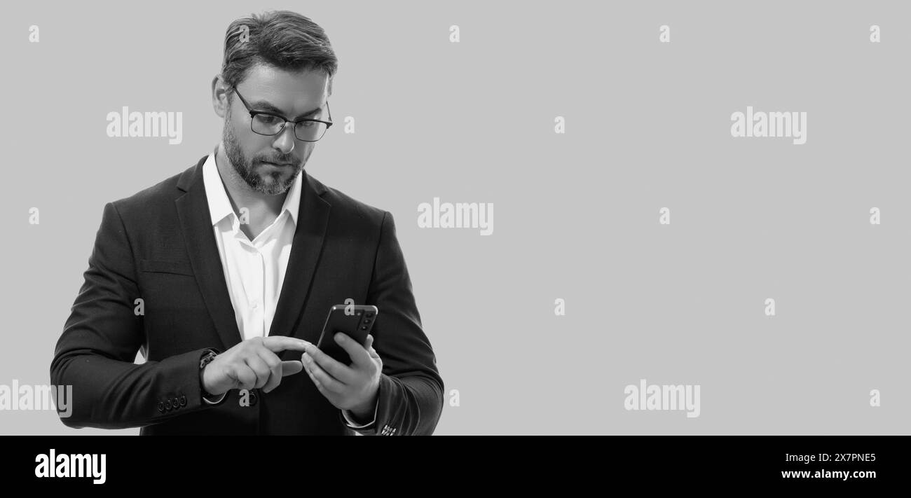 Man in suit using smart phone. Portrait attractive cheerful guy using ...