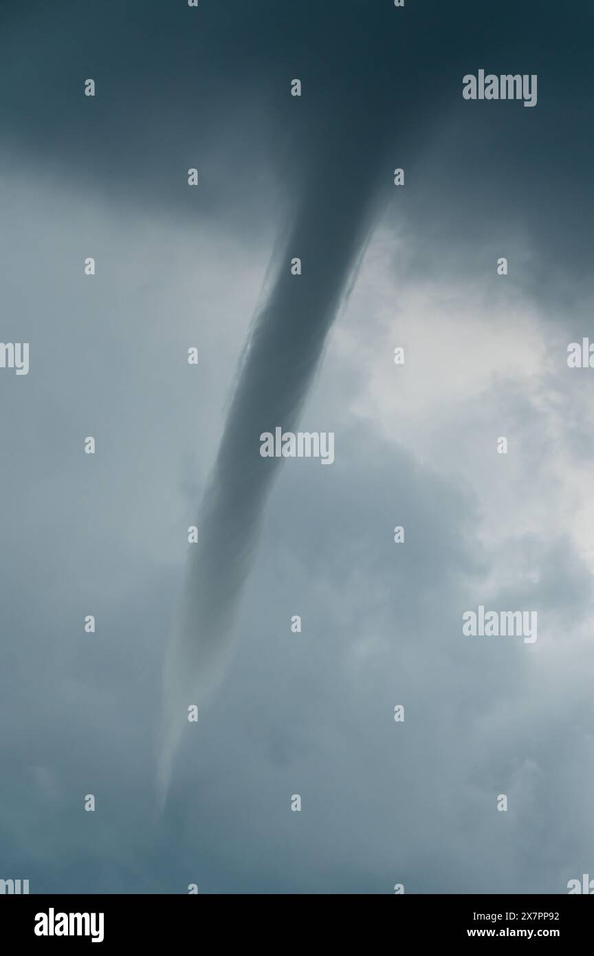 A tornado coming out of a supercell in Europe. A tornado is a violently ...