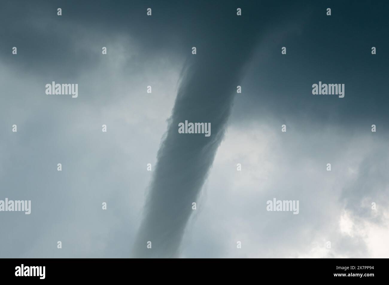 A tornado coming out of a supercell in Europe. A tornado is a violently ...