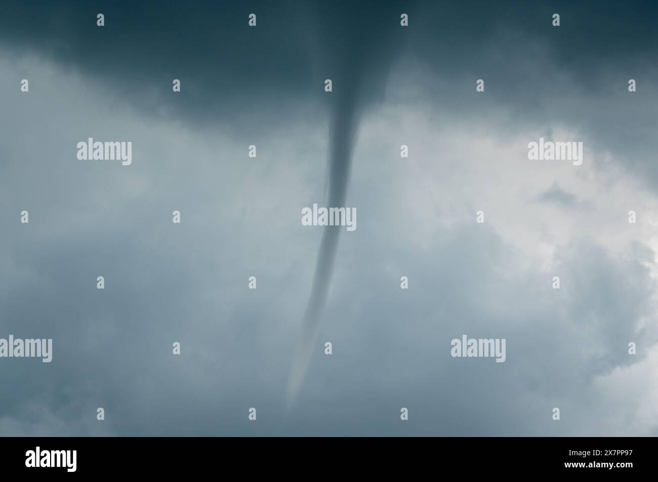 A tornado coming out of a supercell in Europe. A tornado is a violently ...