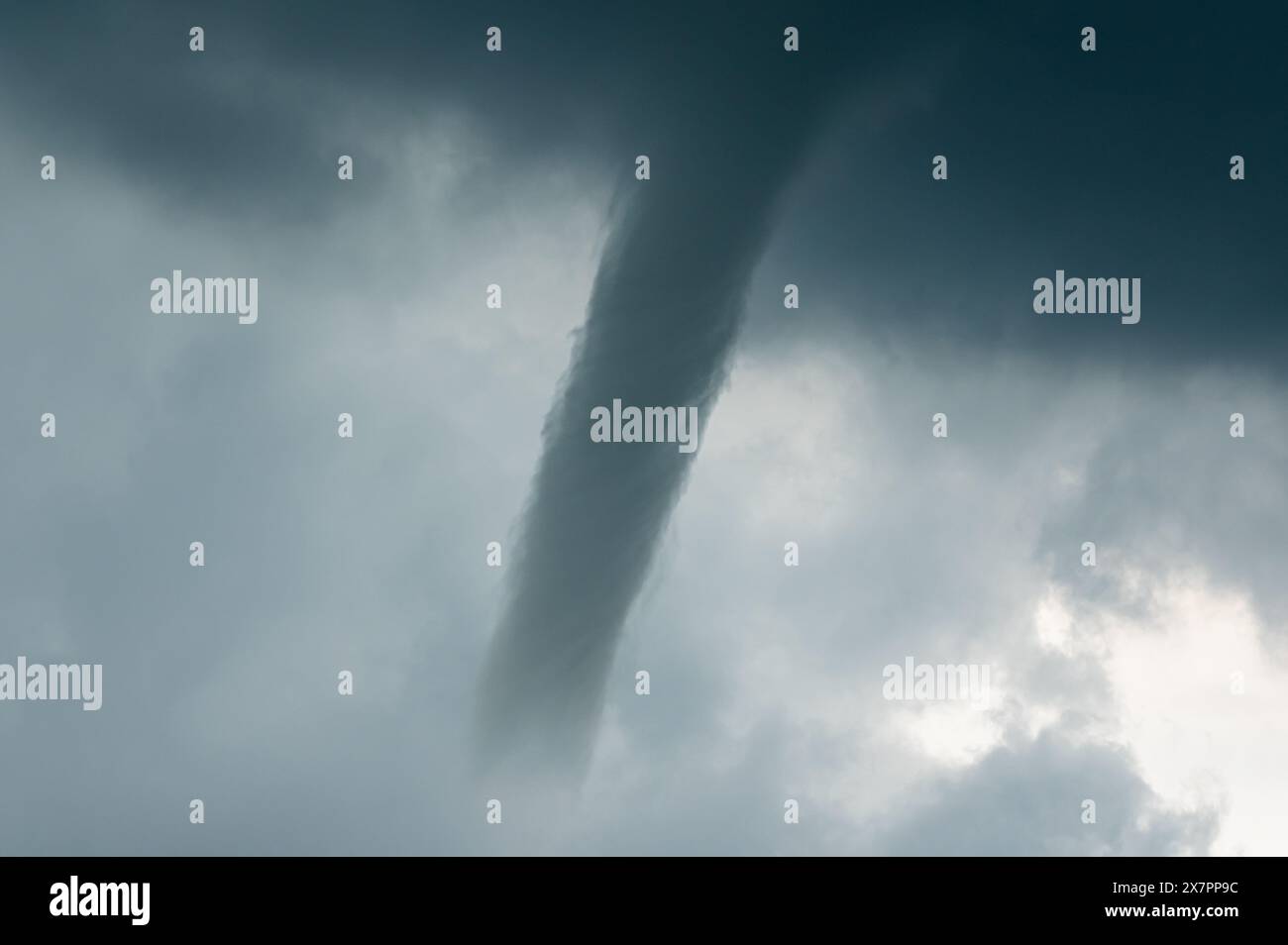 A tornado coming out of a supercell in Europe. A tornado is a violently ...