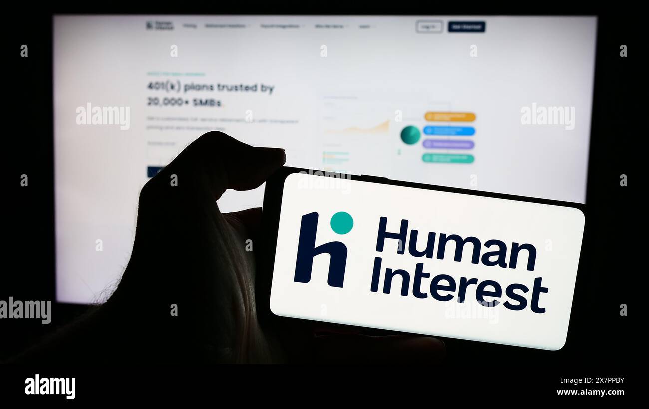 Person holding mobile phone with logo of American financial services ...