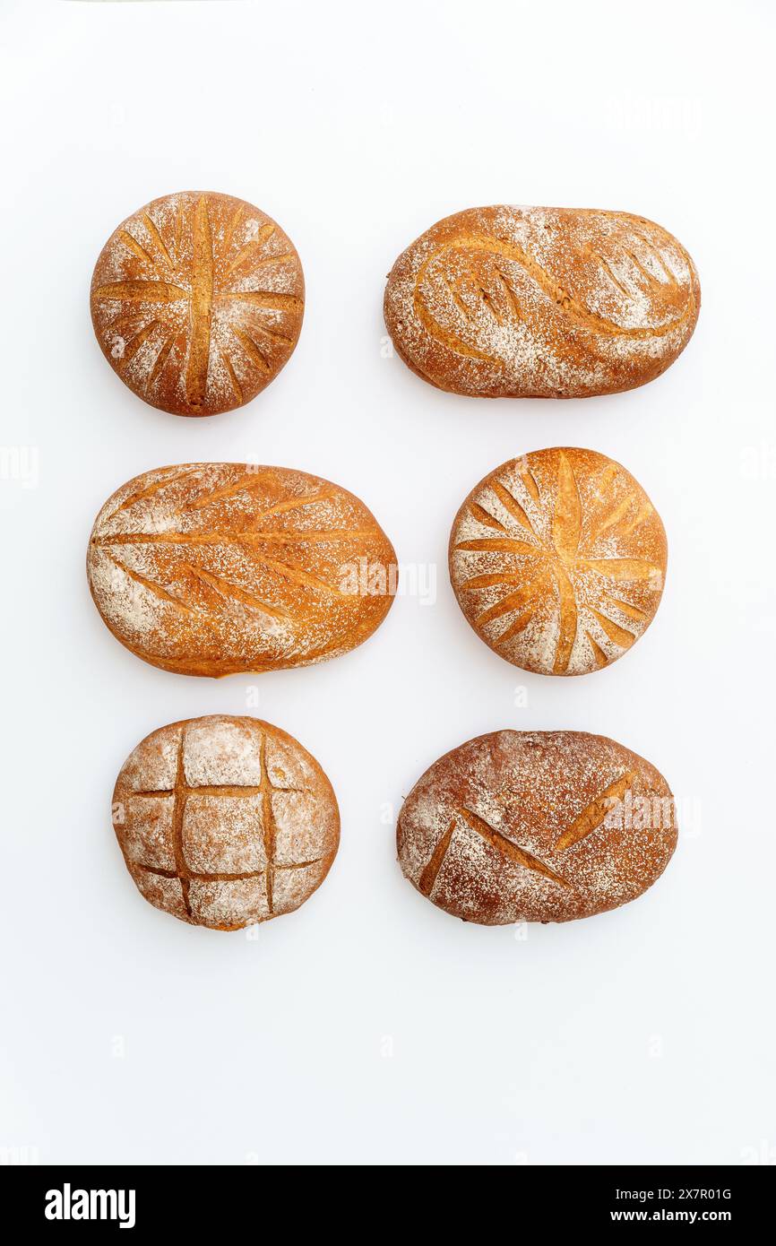 An array of freshly baked sourdough breads with distinct artisanal ...