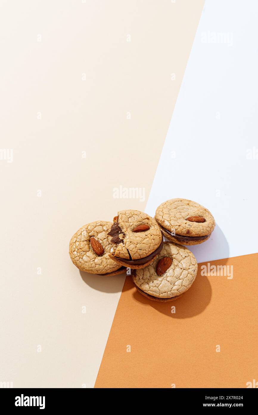 Gourmet nut biscuits arranged artistically on a dual-tone beige and ...