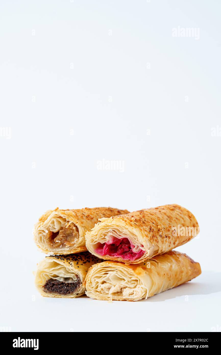 A selection of delicious layered puff pastry rolls with various sweet ...