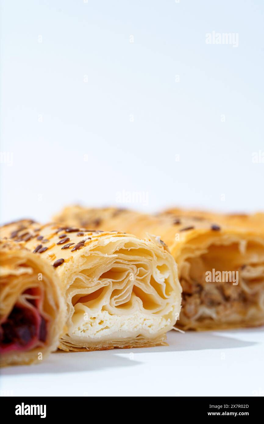 A selection of flaky pastry rolls with various fillings, garnished with ...