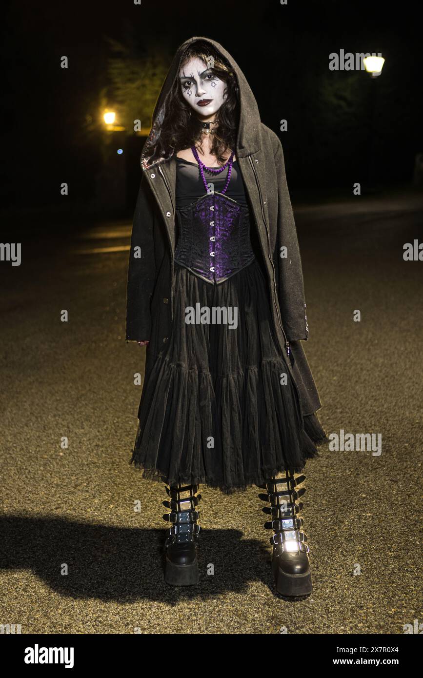 A woman gazes into the camera with haunting eyes, dressed in a gothic ...