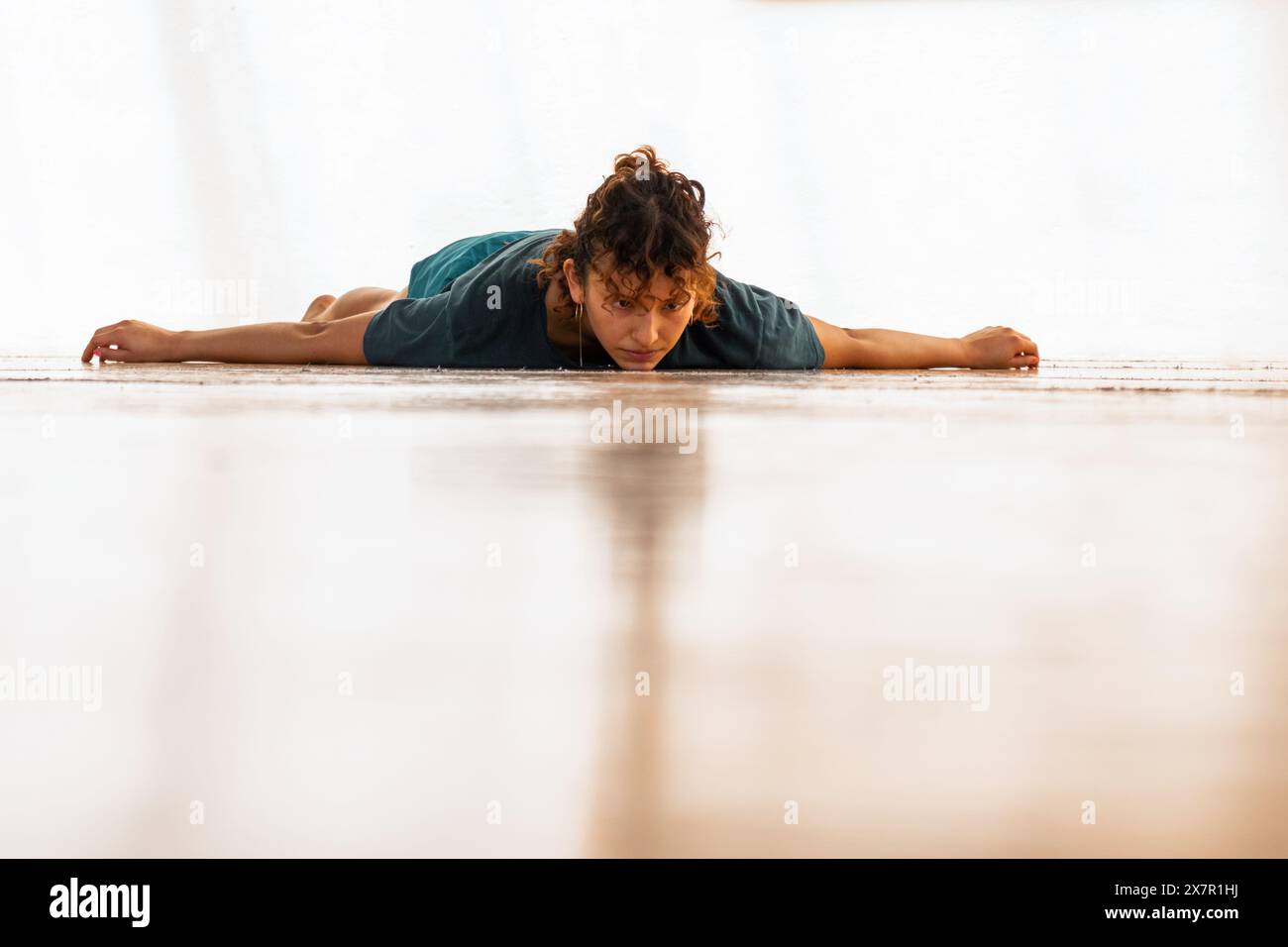 An individual is engaged in a holistic dance movement, lying stretched ...