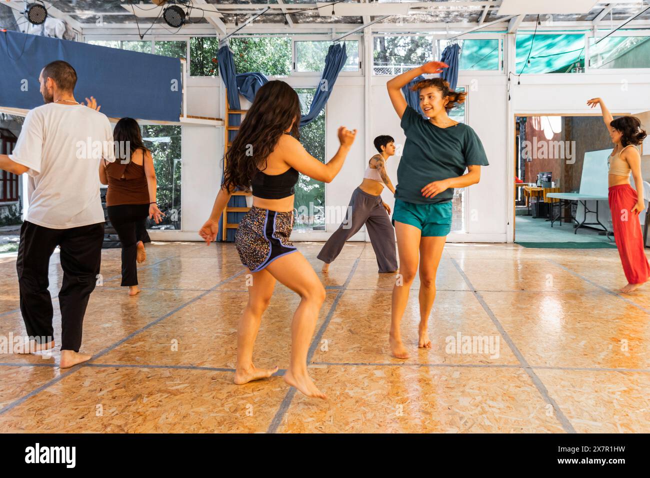 A group of individuals engaging in a holistic dance ceremony inside a ...