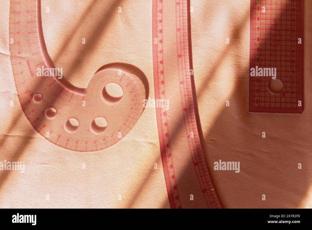 Tailoring tools, including a curved ruler and a straight ruler, cast ...