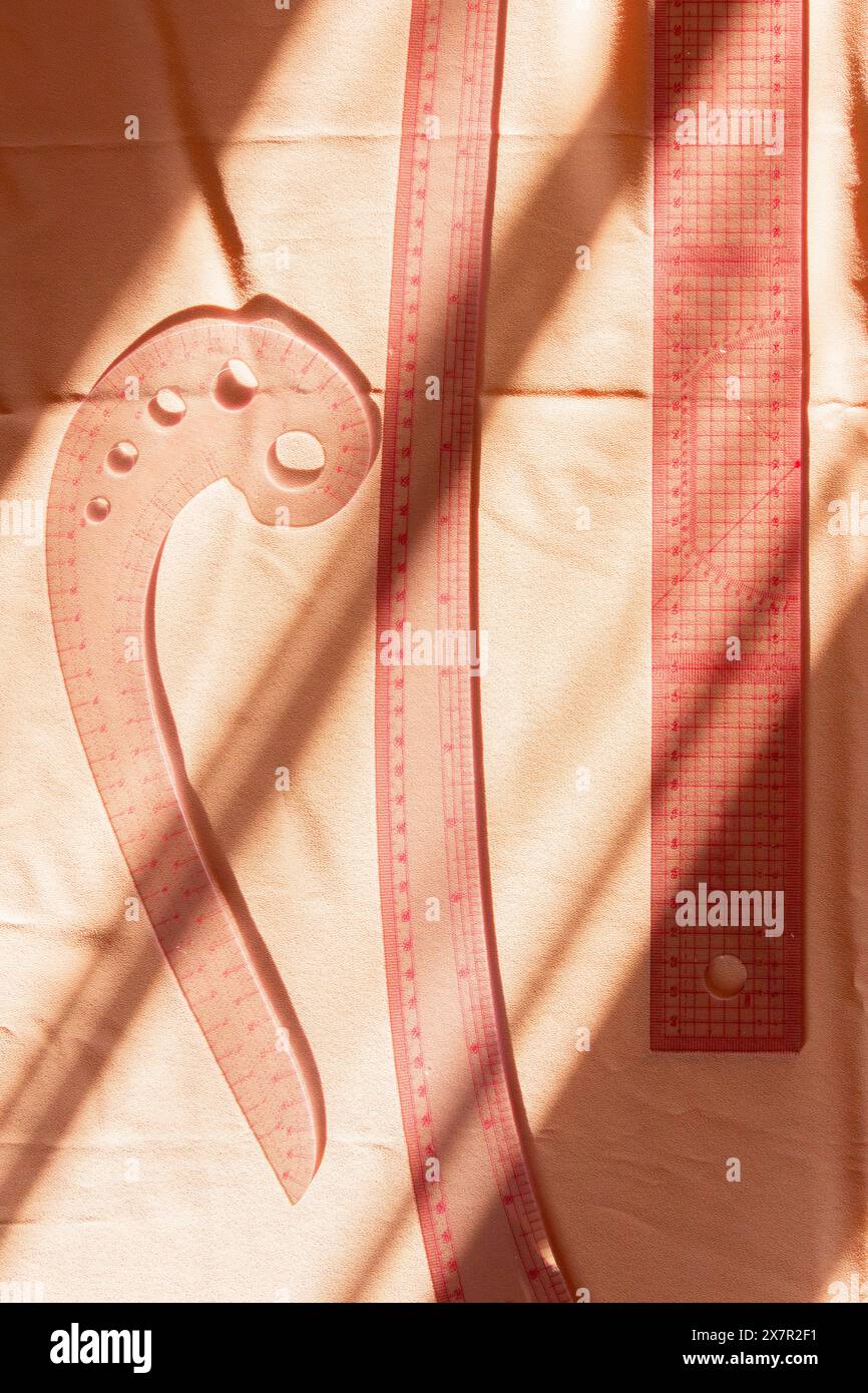 Sewing tools such as a French curve and measuring tape cast soft ...