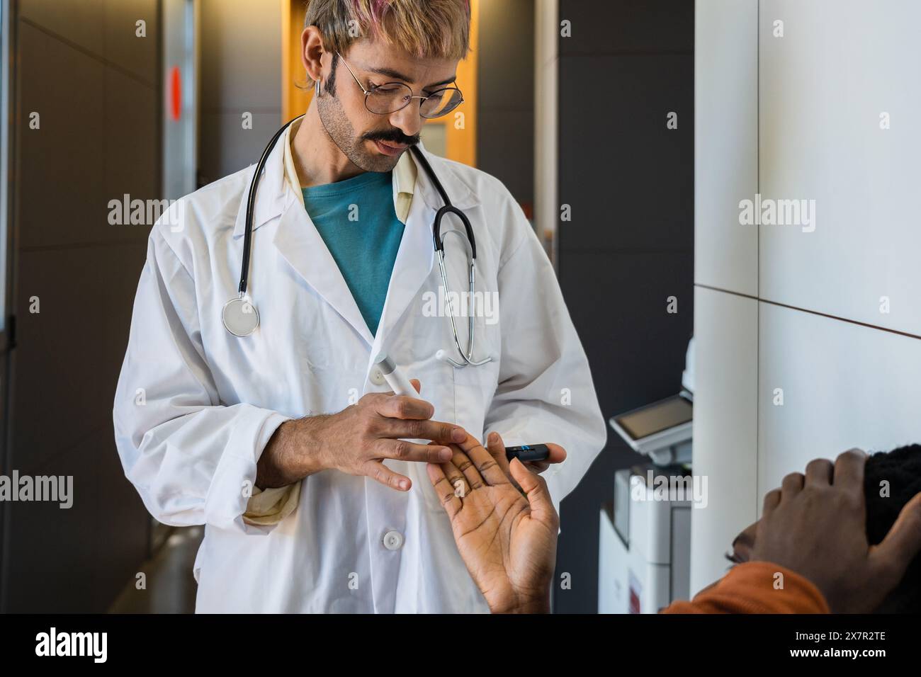 A concerned male doctor in a white lab coat tests a patient blood sugar ...
