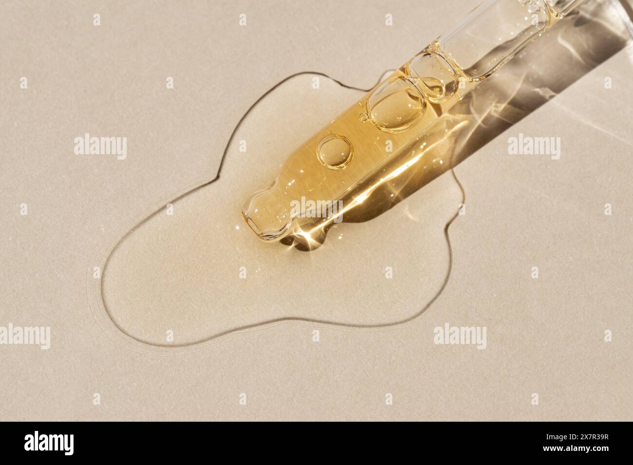 A close-up image showcasing the detailed texture of golden serum and ...