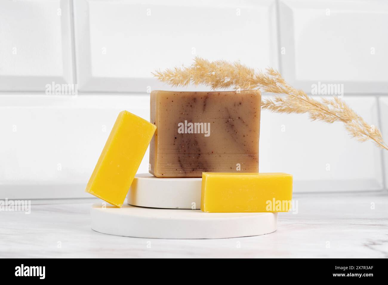 Artisanal natural soaps in yellow and brown, accented with a delicate ...