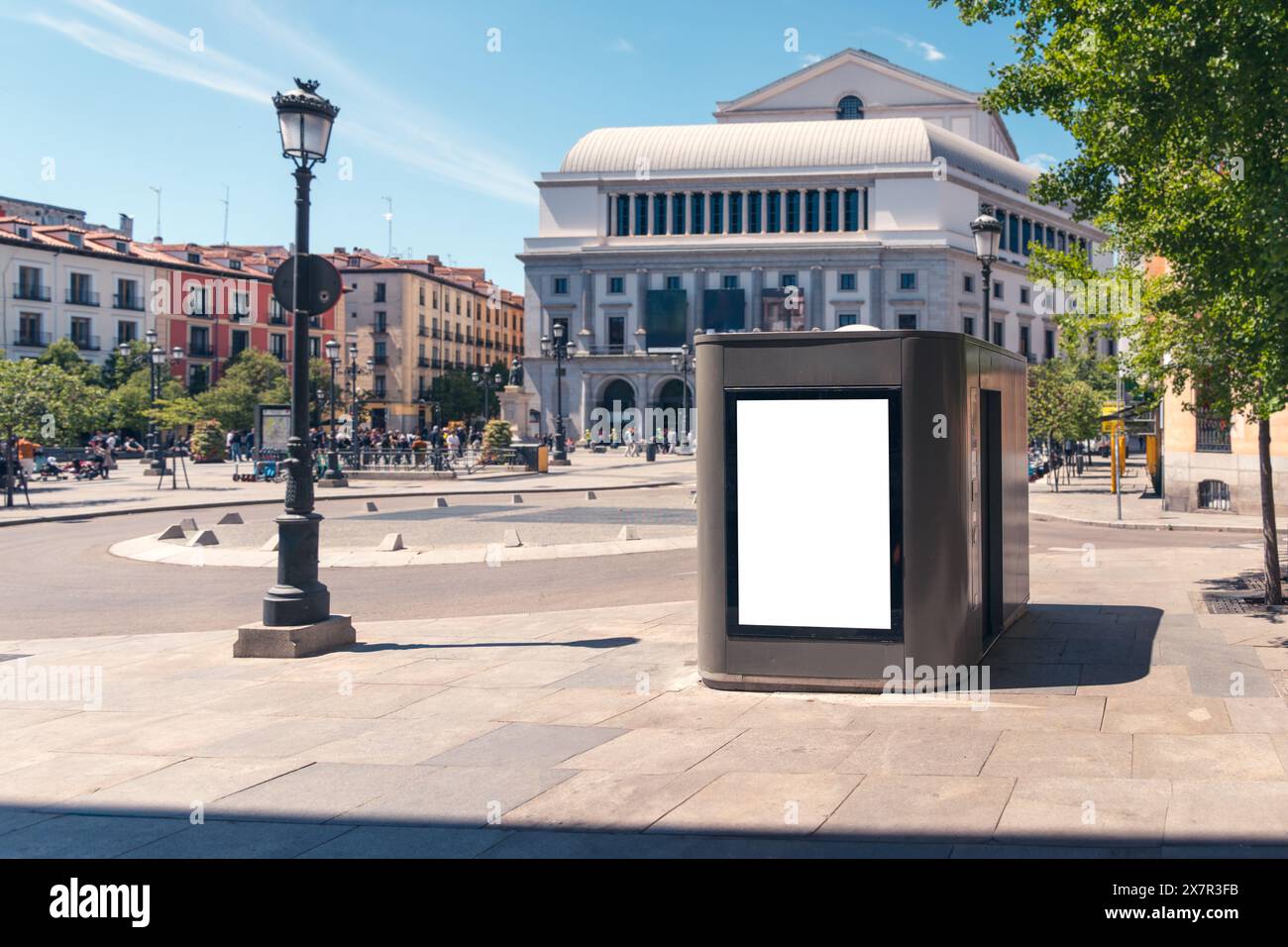 An empty billboard mockup on a busy street in Madrid, surrounded by ...