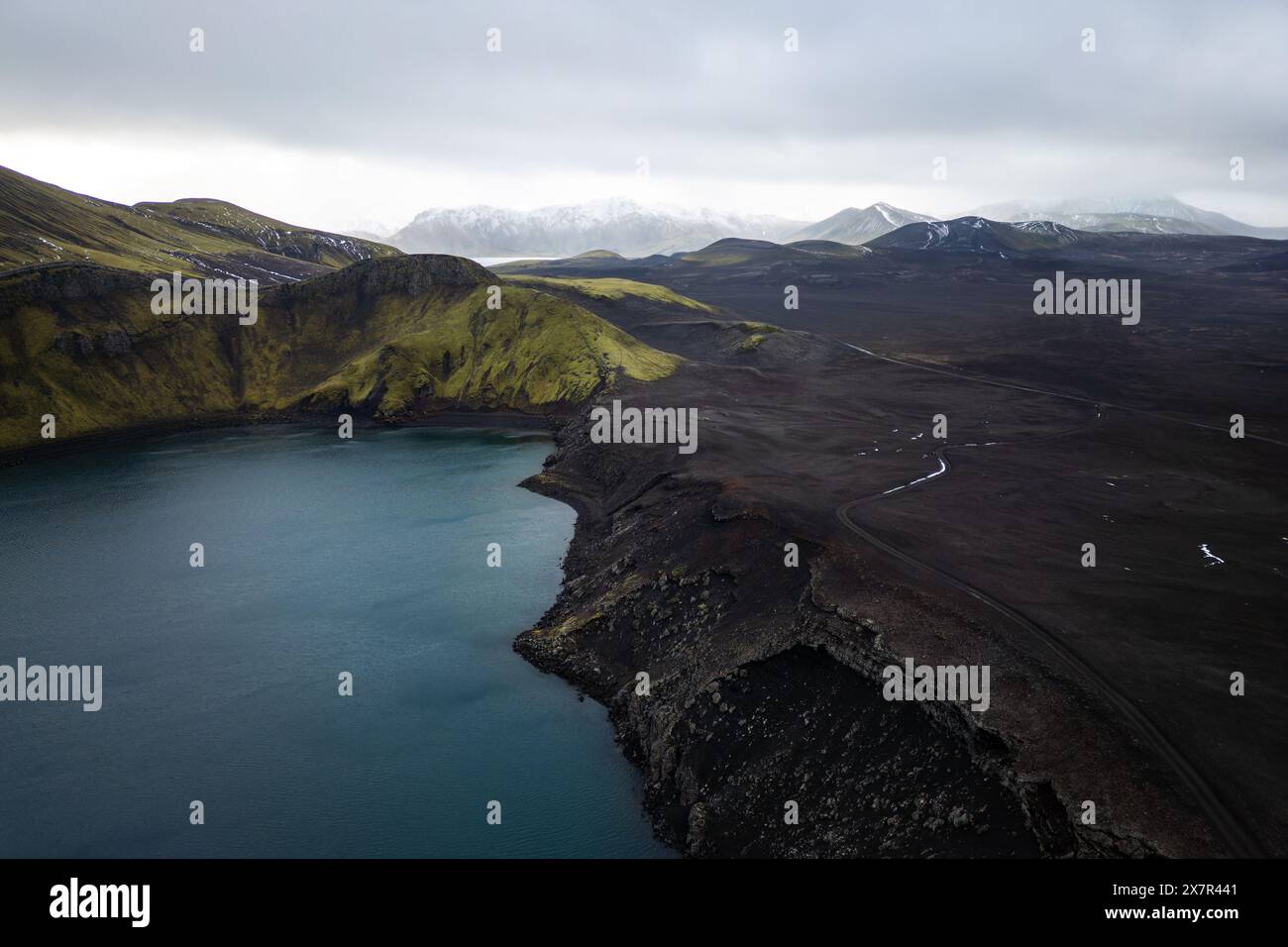 An aerial shot captures the serene beauty of a highland lake flanked by ...