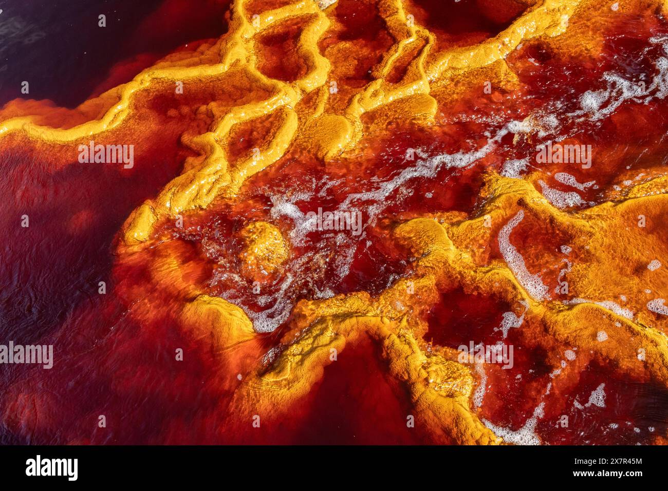 An aerial shot captures the stunning vibrant red and yellow mineral ...