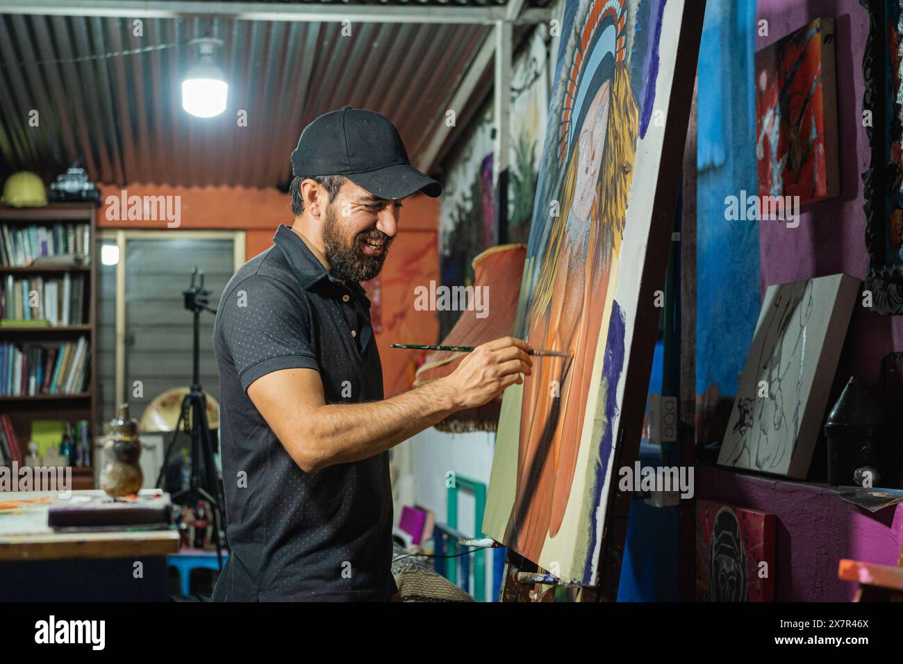 Side view of passionate Latin American artist intensely focuses as he ...