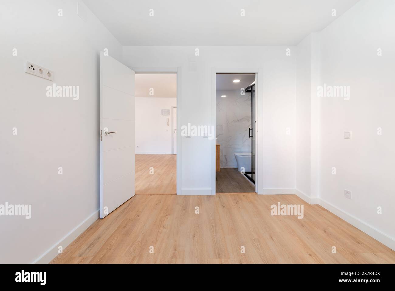 A contemporary empty apartment features a spacious room with polished ...