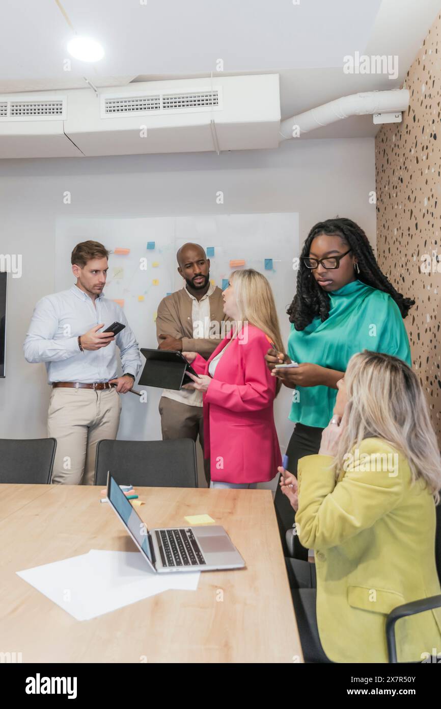 Diverse group of professionals collaborating in a well-lit coworking ...
