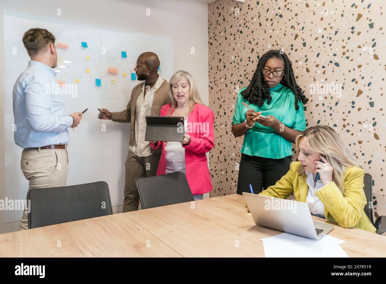 A team of professionals engages in a collaborative session in a stylish ...