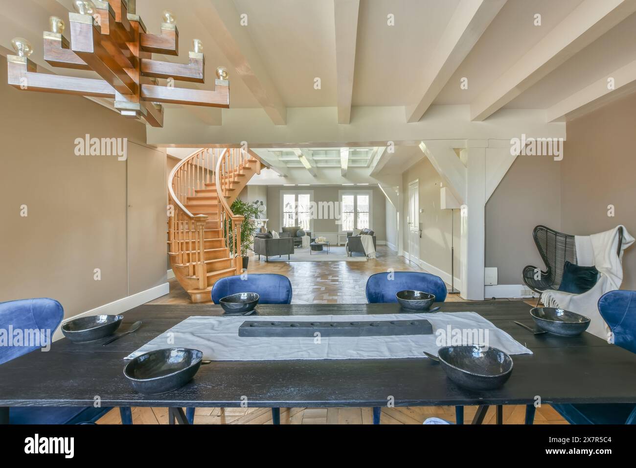 This beautifully designed open-plan living room features a grand wooden ...