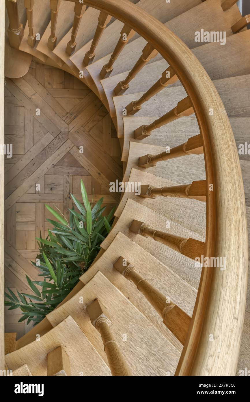 Overhead view of a gracefully curved wooden spiral staircase, featuring ...