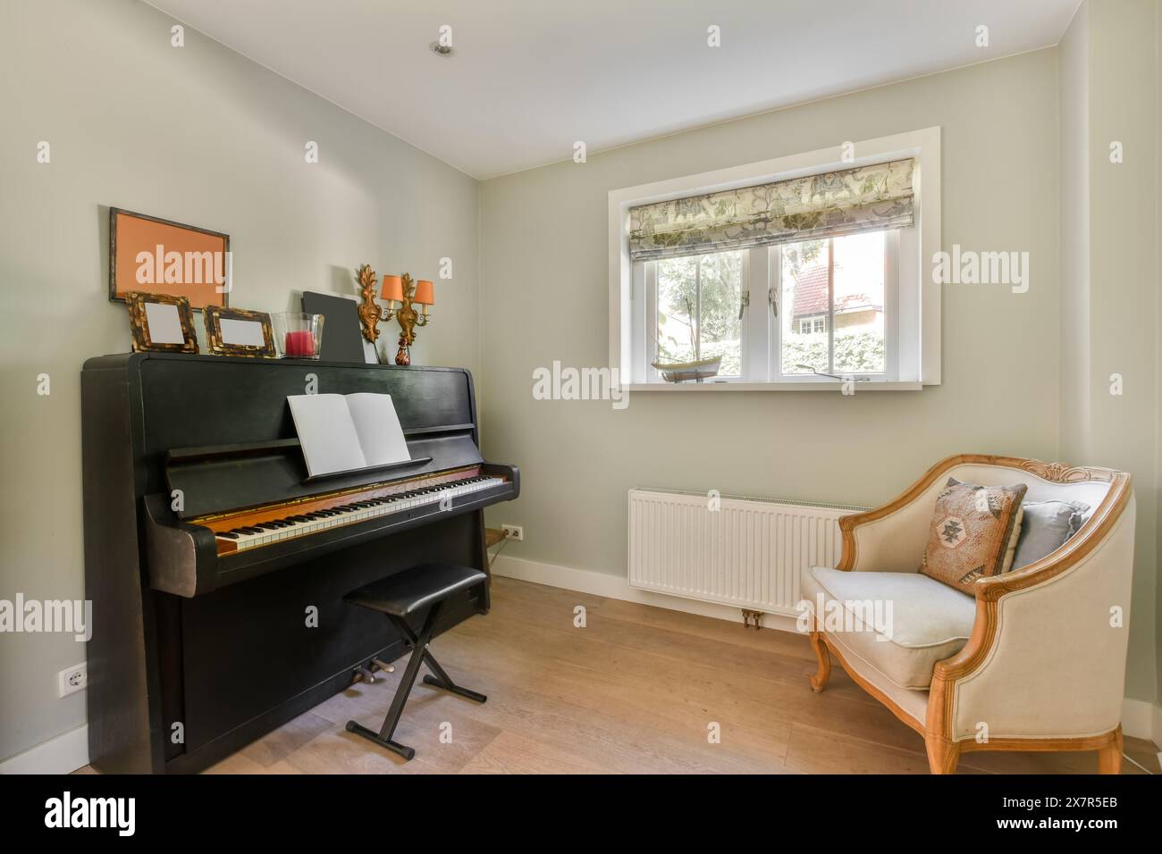 Elegant and inviting room featuring a black upright piano, framed ...