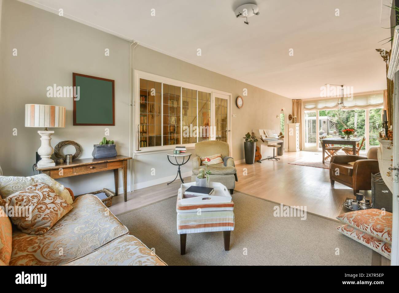 A well-appointed living room seamlessly connects to a tranquil garden ...