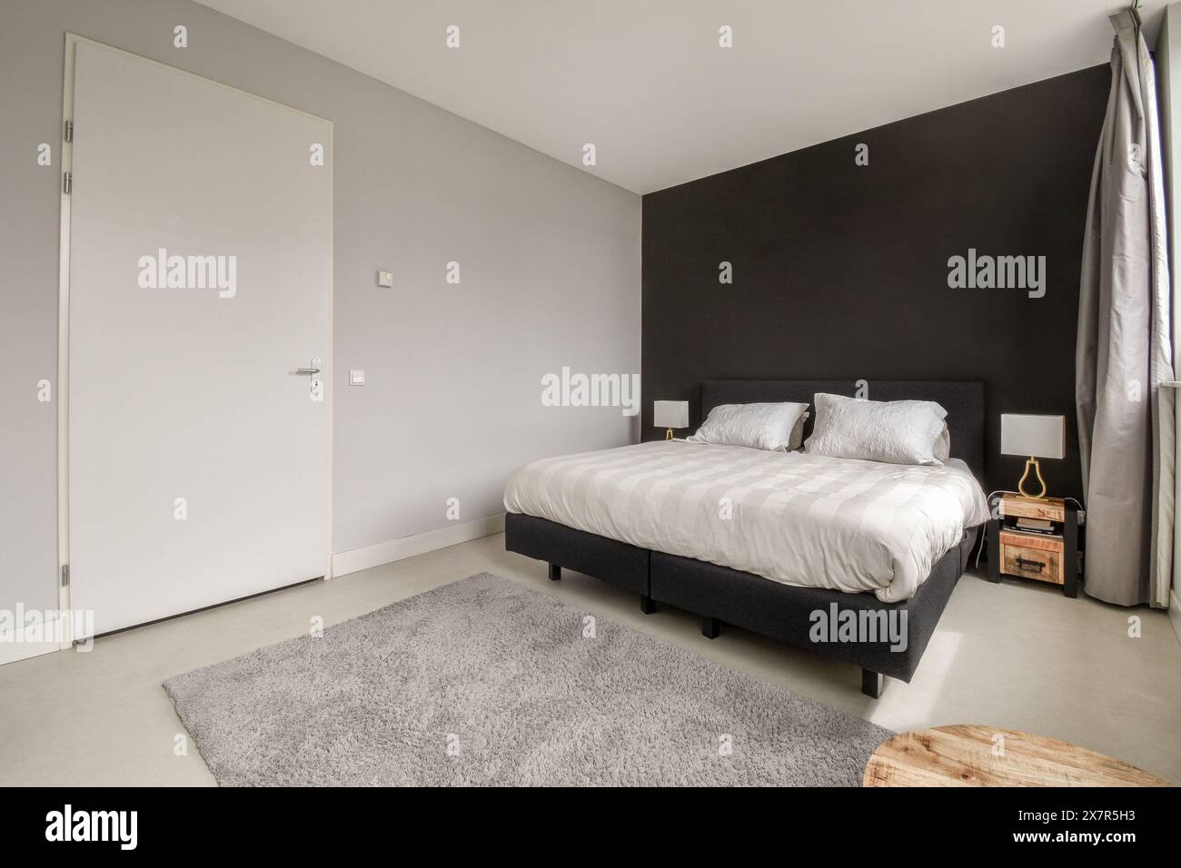 Contemporary bedroom showcasing a clean design with a striking dark ...