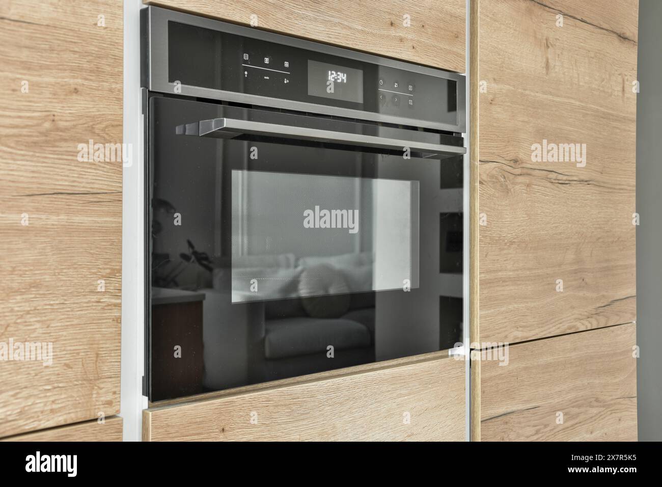 A sleek and contemporary built-in microwave oven with a digital display ...