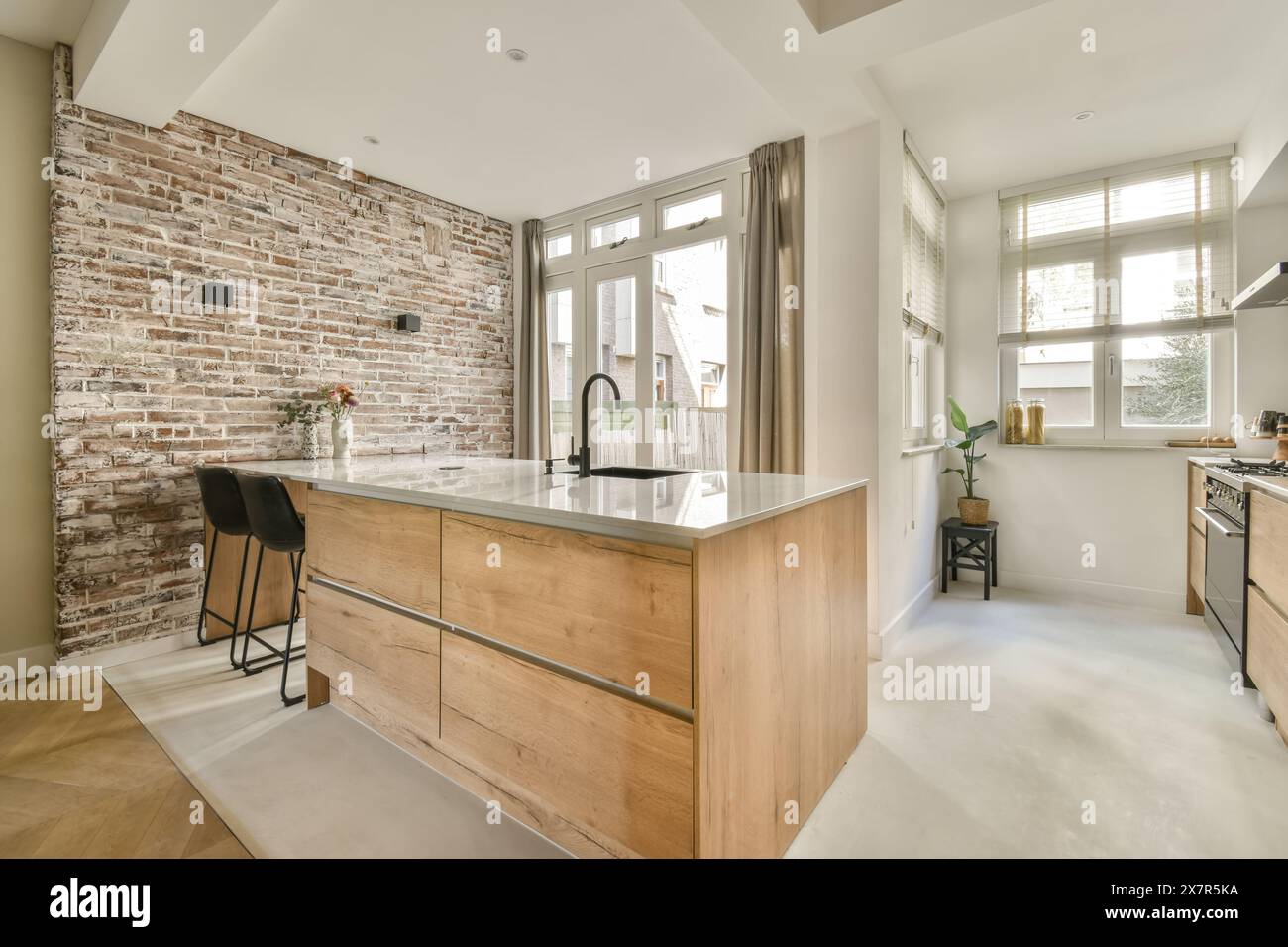A spacious kitchen featuring a combination of sleek wooden cabinetry ...