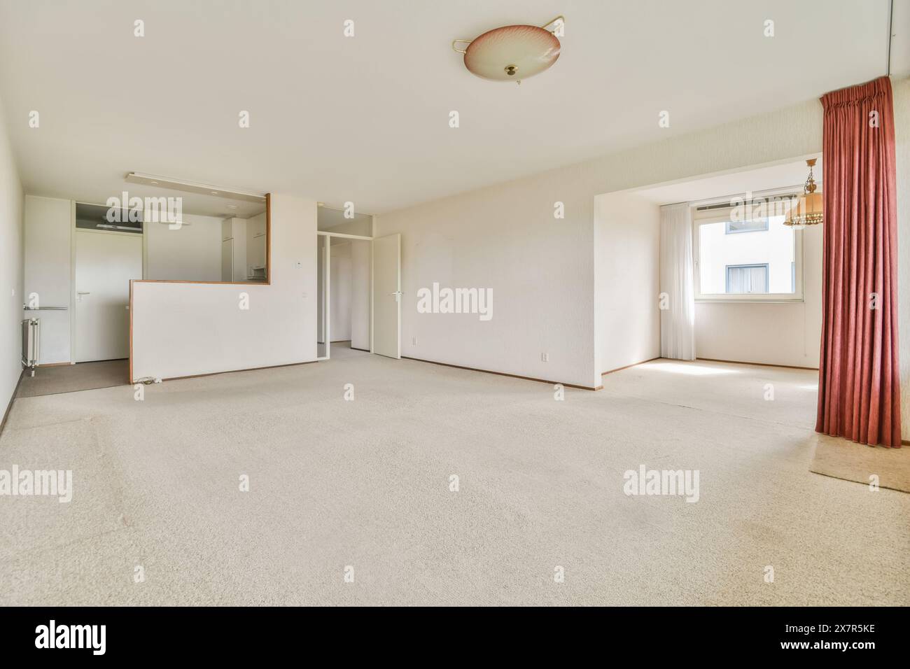 A bright and spacious unfurnished apartment featuring a large carpeted ...
