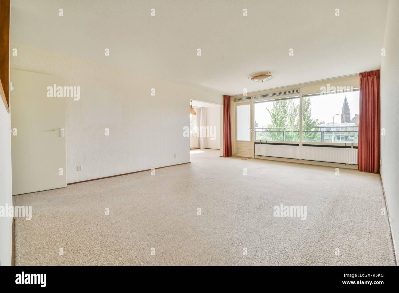 This image features a large, well-lit living room with expansive ...