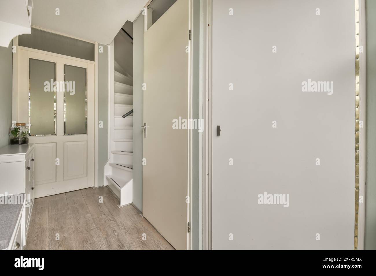 Modern hallway with cabinets and a staircase and doors Stock Photo - Alamy
