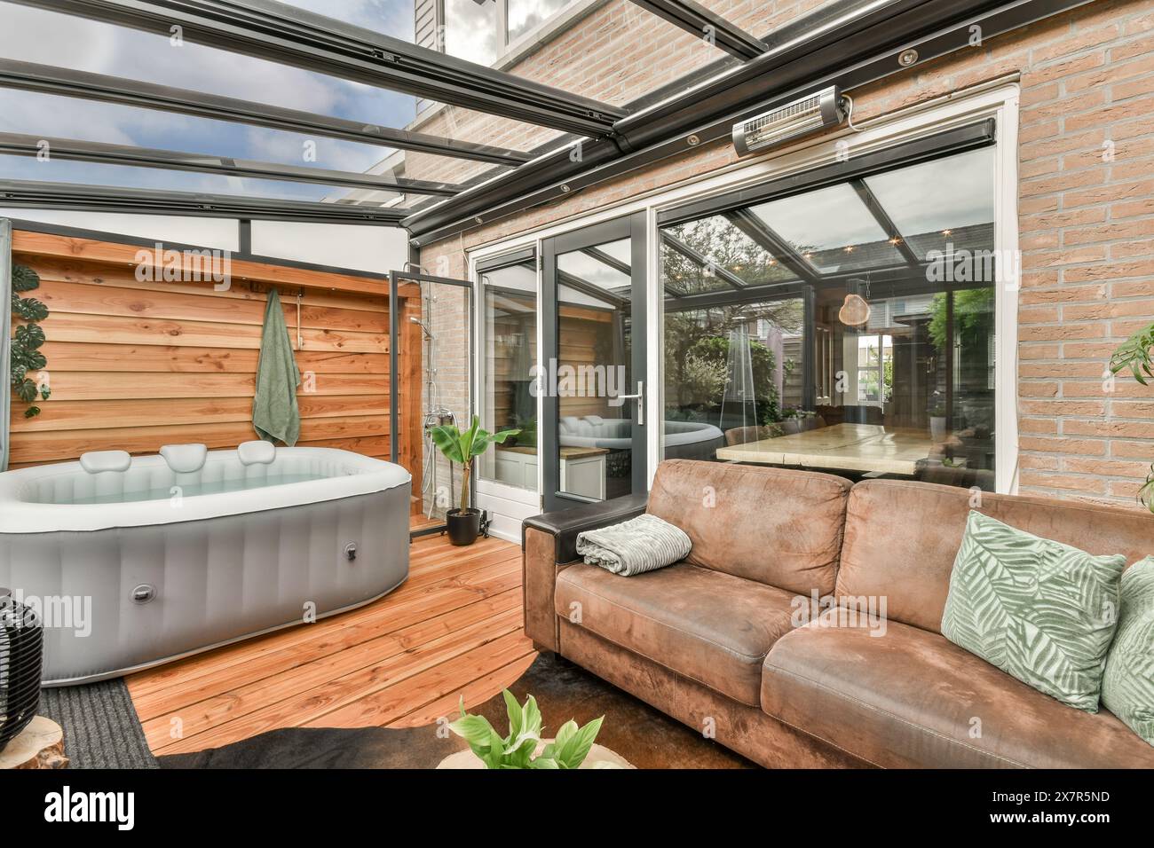 Elegant conservatory space enclosed with glass panels, featuring a ...