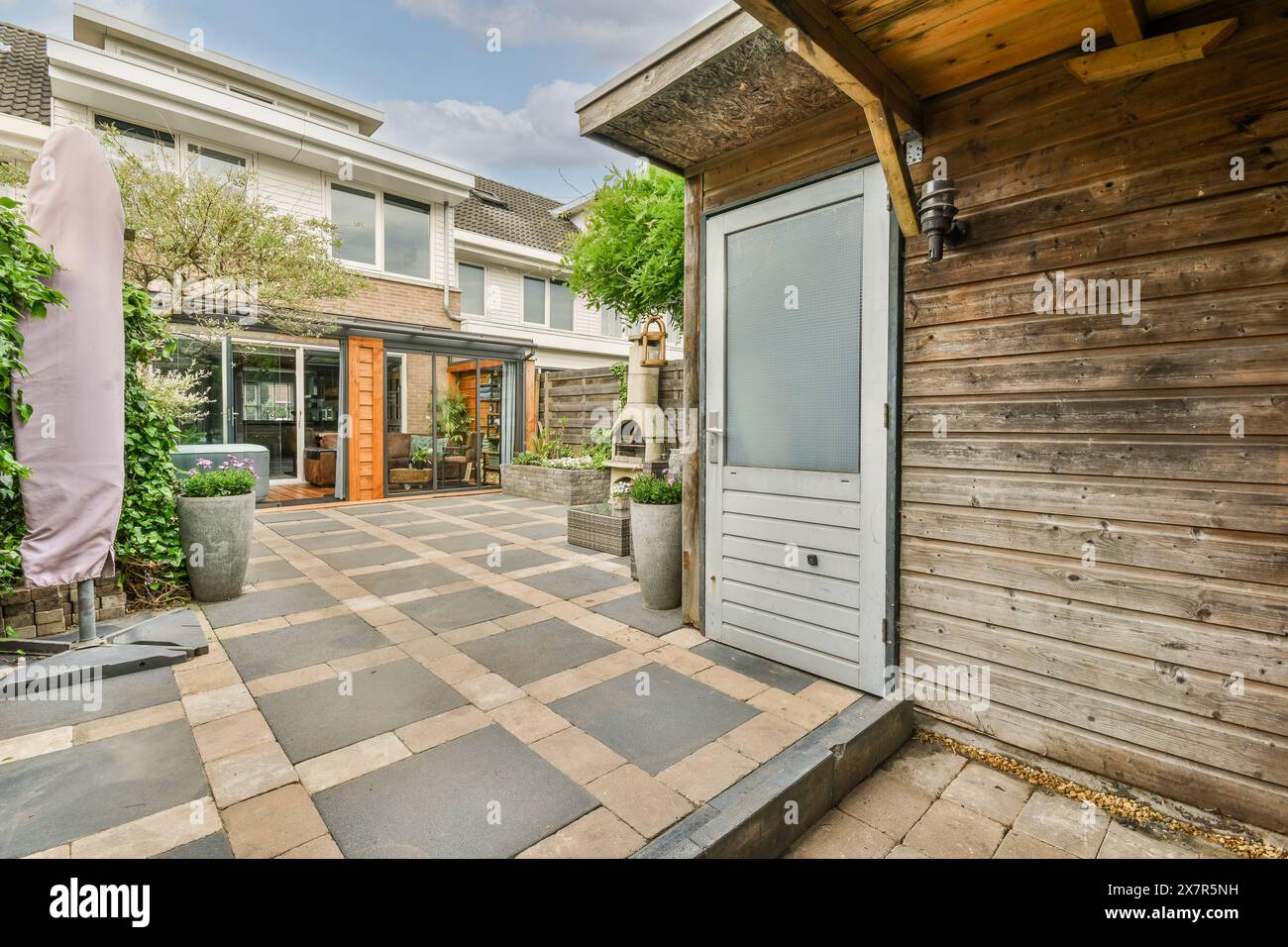 A well-maintained backyard patio area of a contemporary suburban house ...