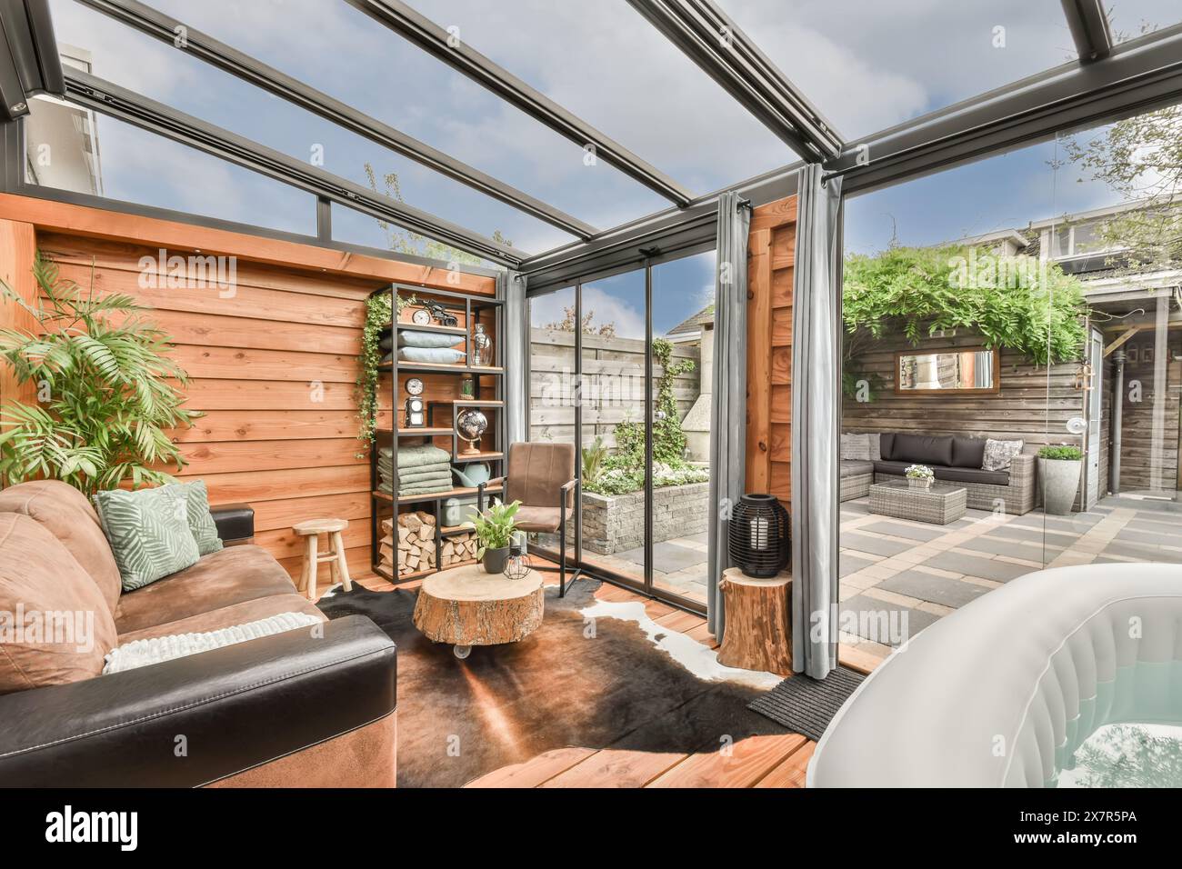 A modern conservatory featuring a comfortable living space with stylish ...