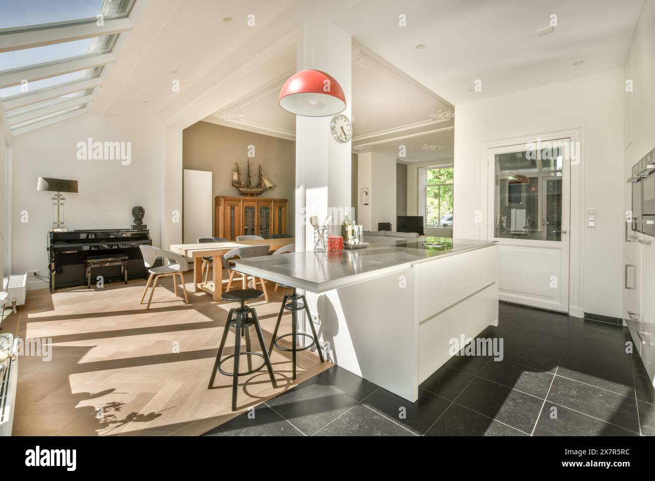 Spacious modern kitchen with ample natural lighting, featuring stylish ...