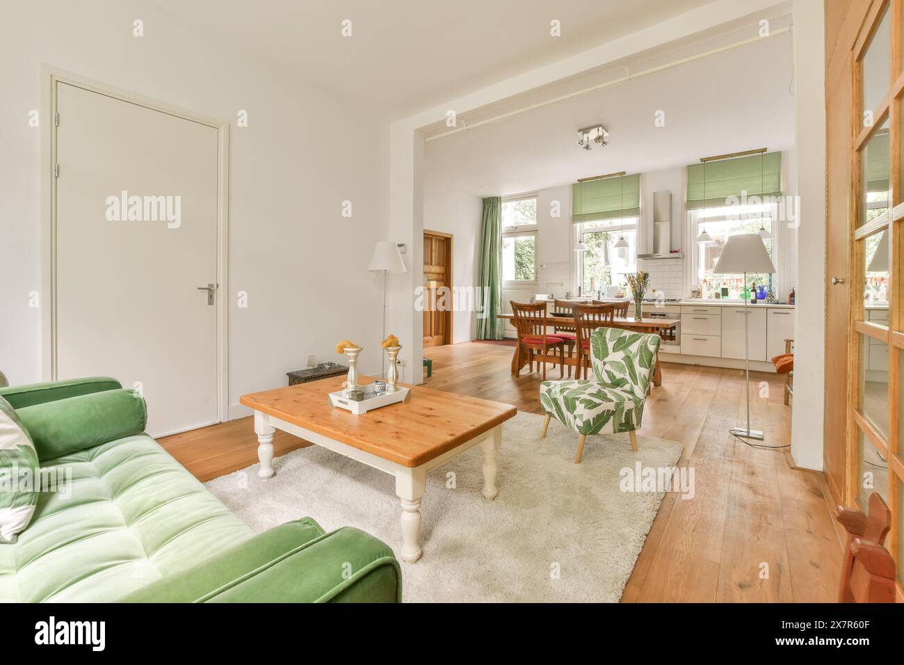 Stylish interior view of a spacious living area connected to a kitchen ...
