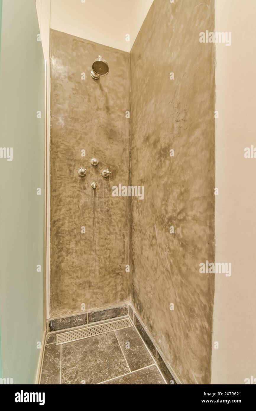 A contemporary shower area with a polished concrete texture on the ...