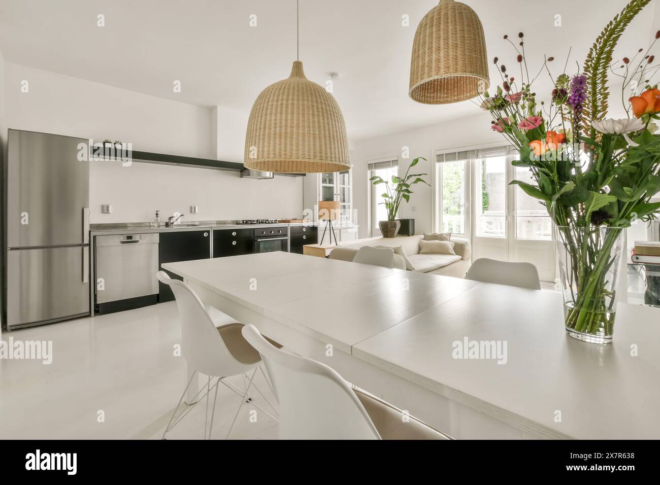 A well-lit, open-plan interior of a modern kitchen with integrated ...